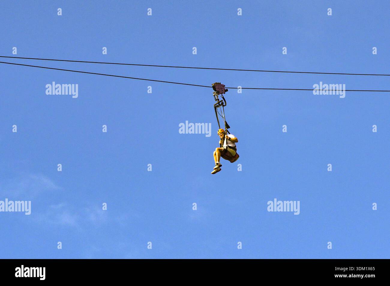 St Maarten, Netherlands - 17 January 2026: Person riding the fast zip ...
