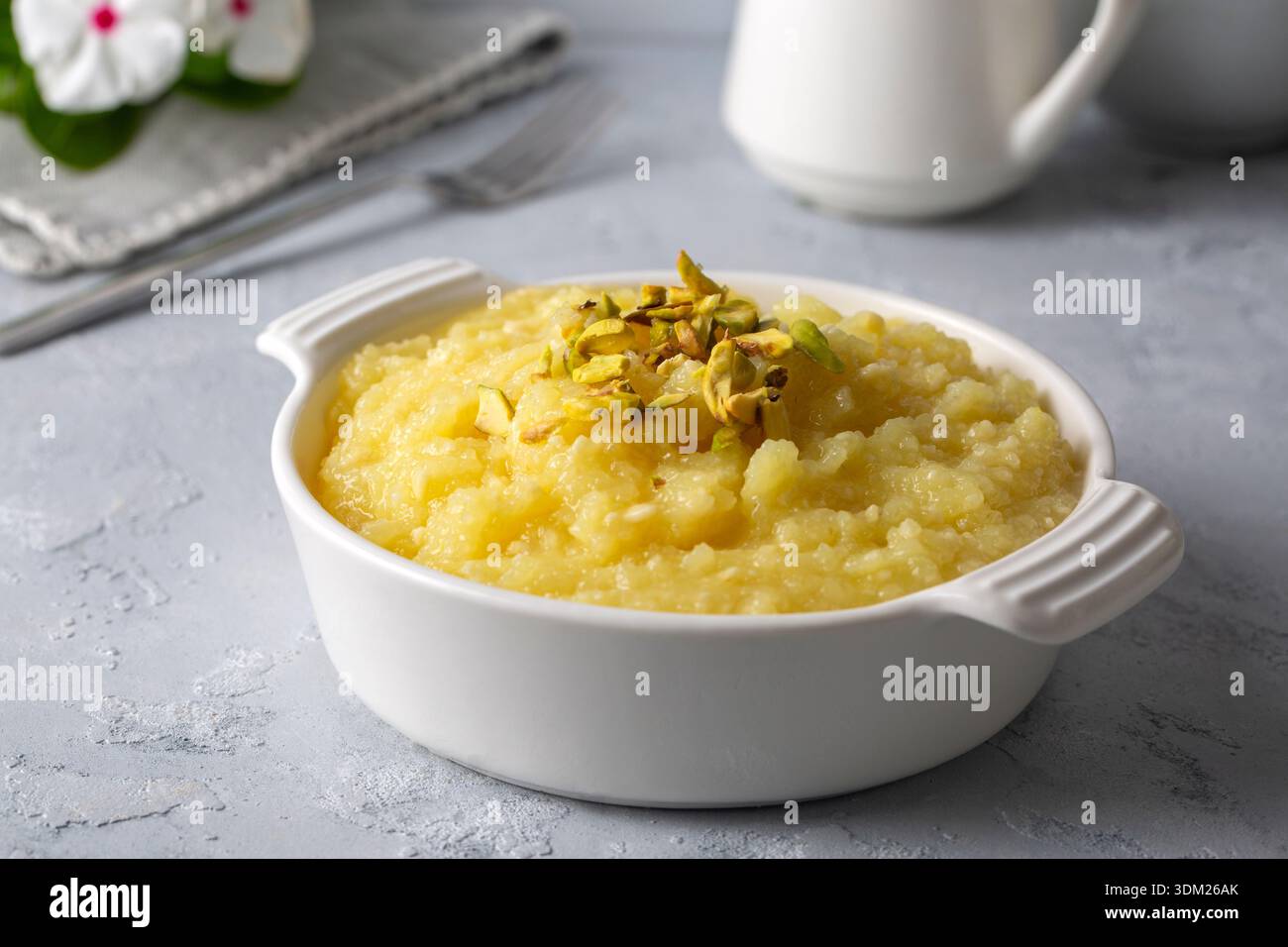Sweet yellow Turkish dessert cheese halva Hosmerim on the white plate ...