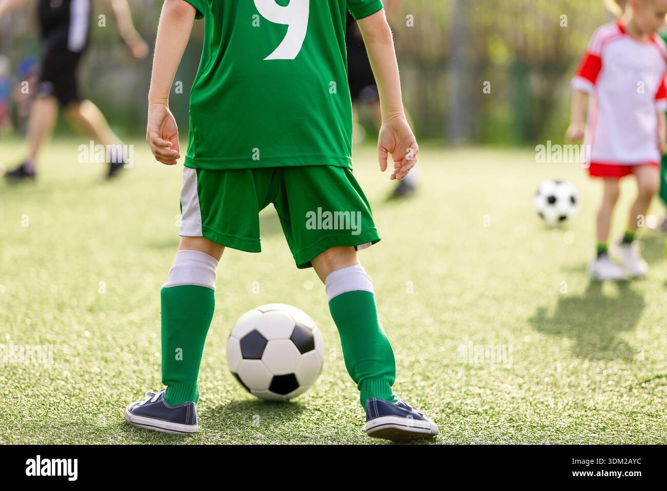 Child Soccer Player in Green Jersey Controlling Ball; Youth Football ...