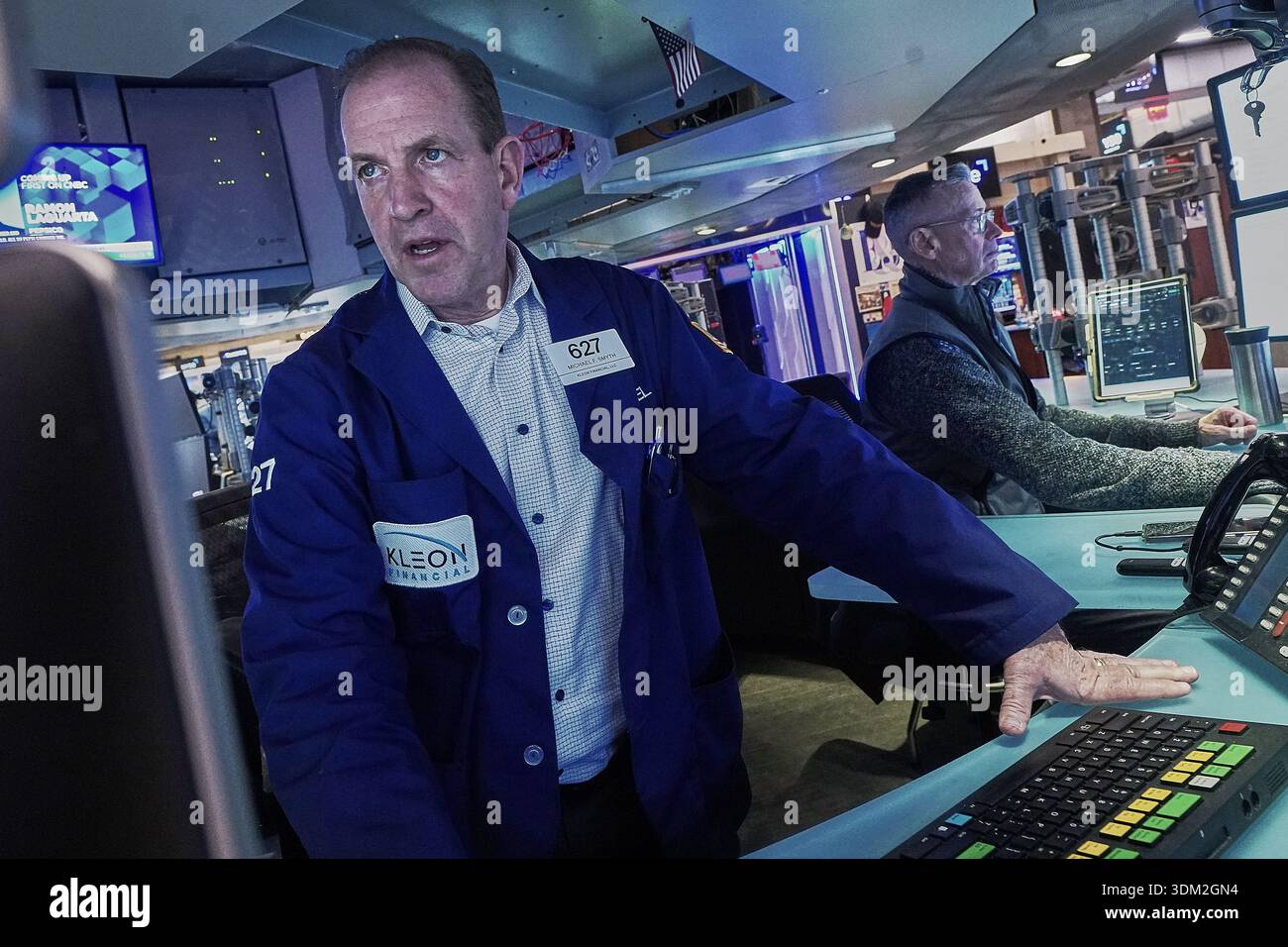 Traders Michael Smyth, left, and Neal Catania work on the floor of the ...