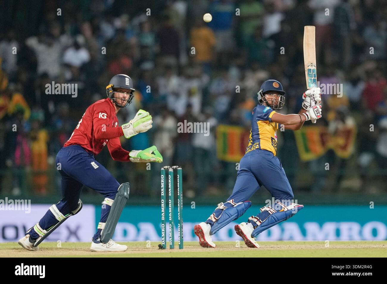 Sri Lanka's Dunith Wellalage, right, plays a shot as England's Jos ...