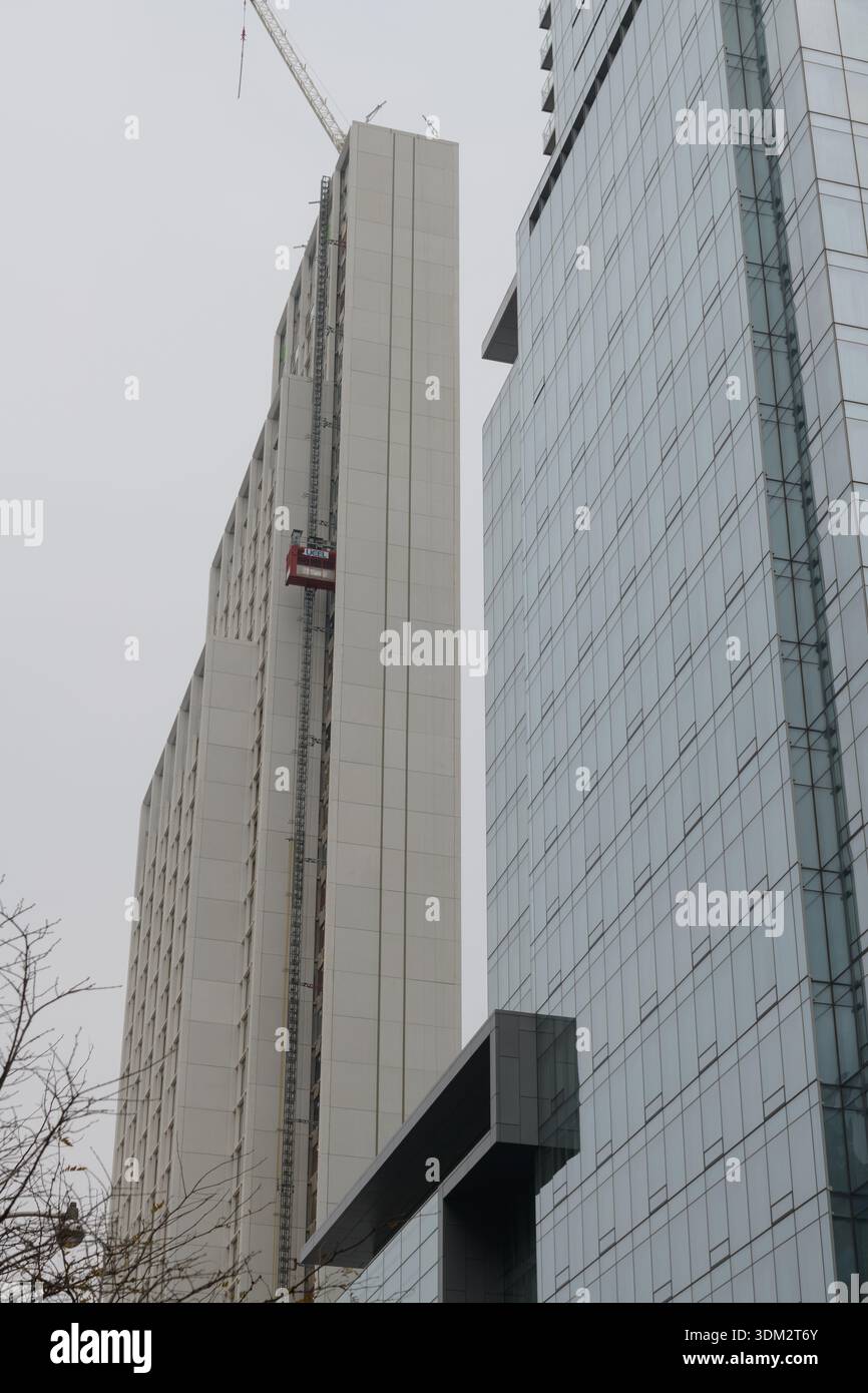 skyward view of 50 Scollard Condos (stone clad structure at center ...