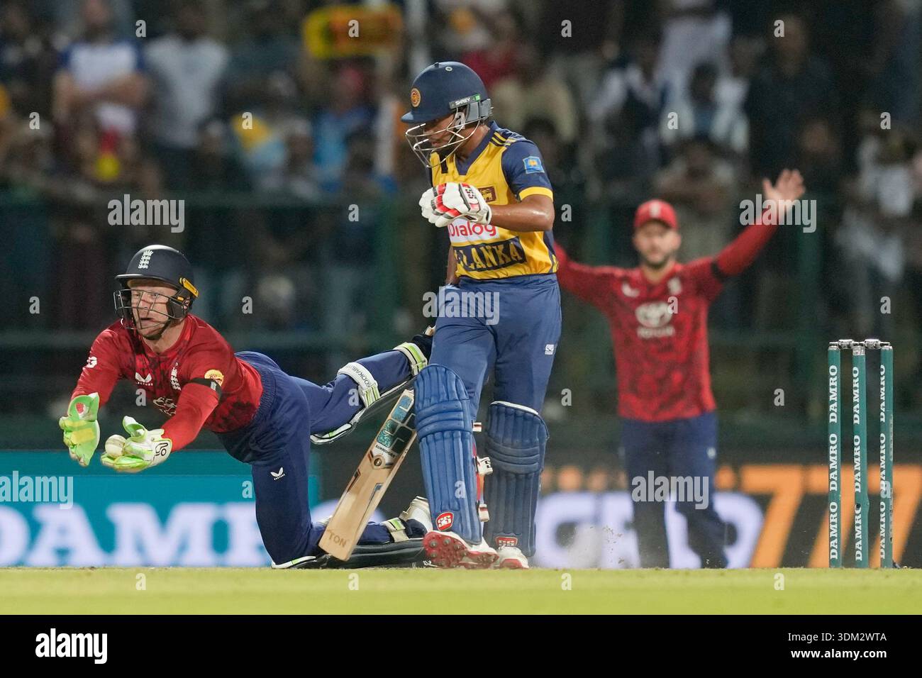 England's Jos Buttler, left, successfully takes the catch to dismiss ...