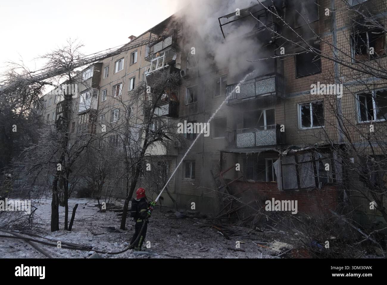 Firefighters put out the fire in an apartment house following a Russian ...