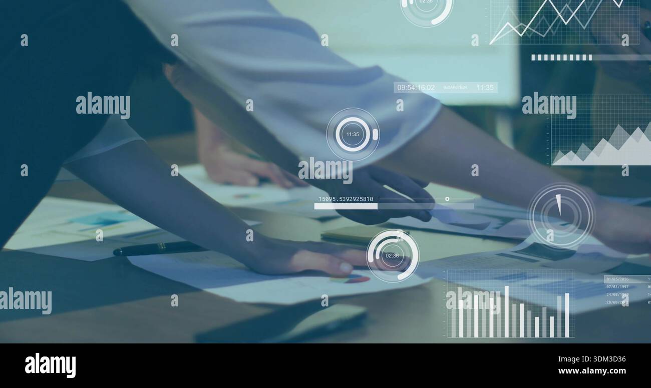 Leaning team reviewing reports at meeting table, with printed charts ...
