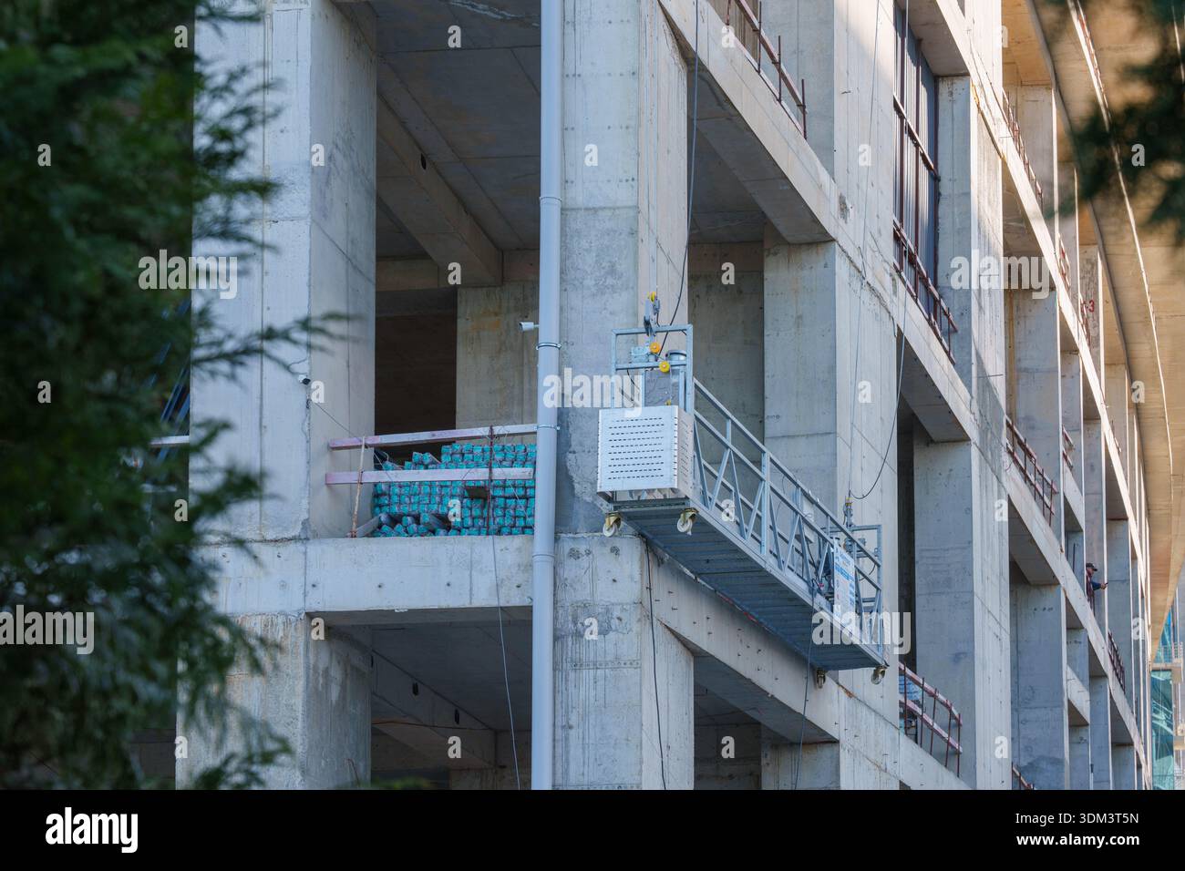 Concrete building under construction with suspended scaffolding ...