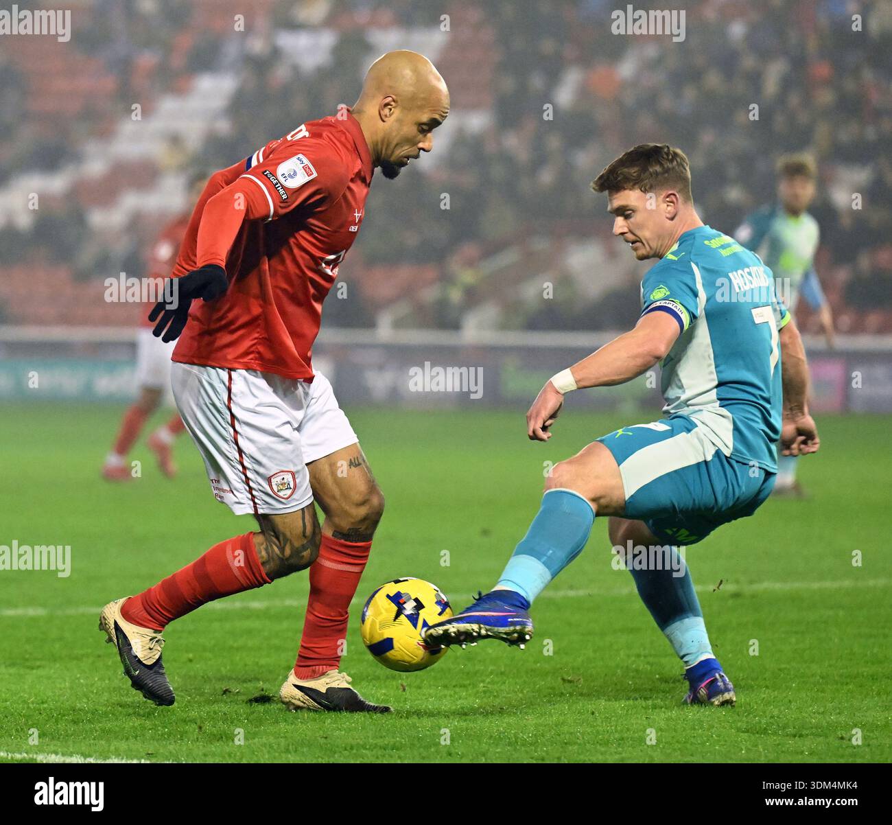 Barnsley's David McGoldrick battles for the ball against Northampton ...