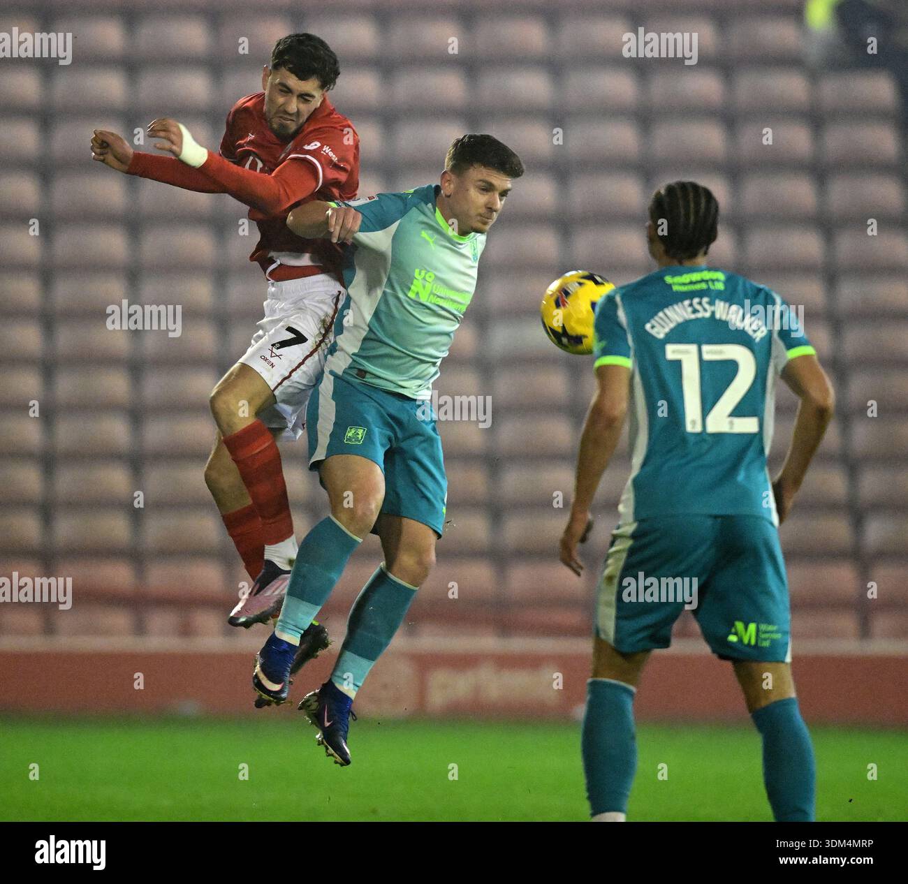 Barnsley's Corey O'Keeffe has an aerial challenge with Northampton Town ...