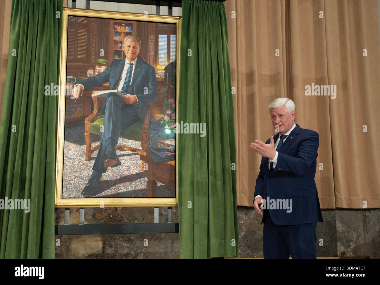 Canada's former Prime Minister Stephen Harper gestures to the artist ...