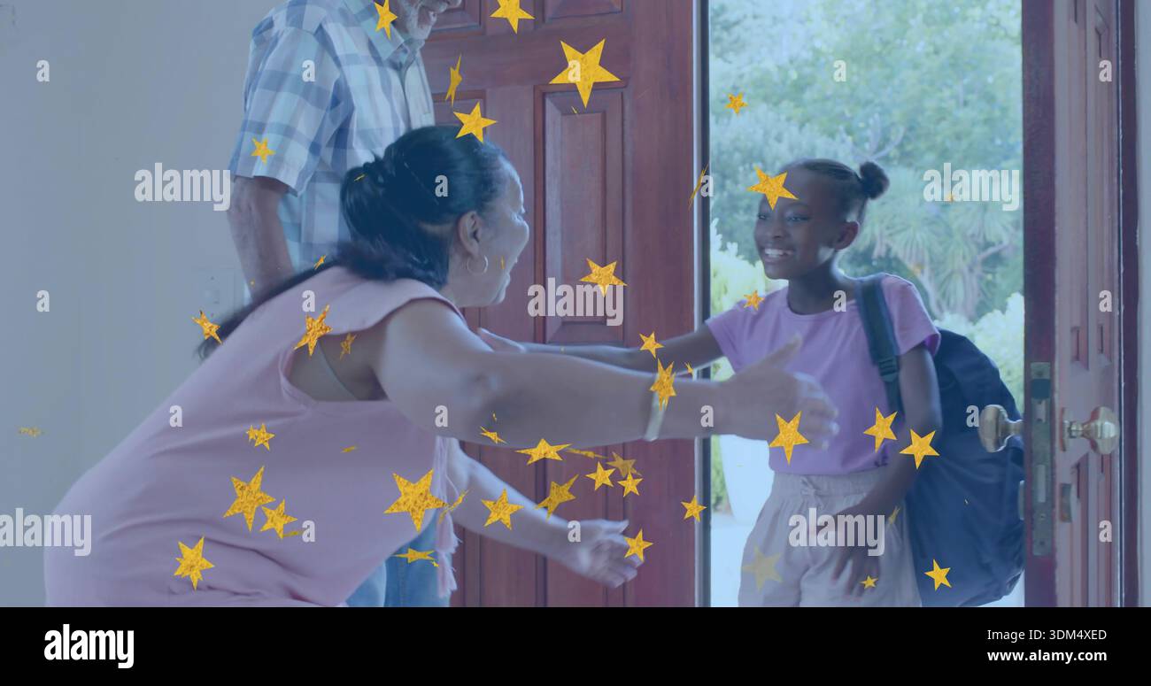 Greeting grandma in pink top reaching for child entering home entry ...