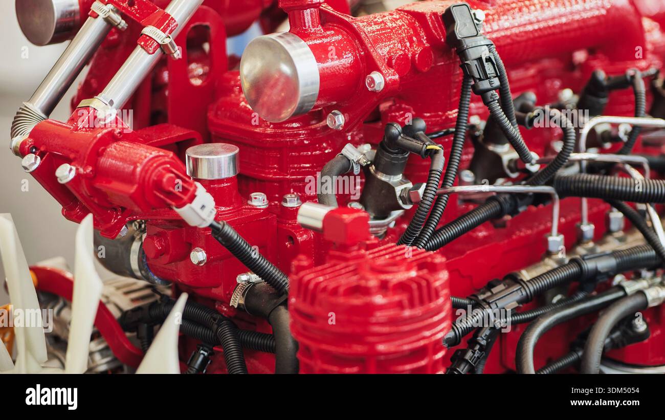 Red industrial engine showing mechanical components, cables, and ...