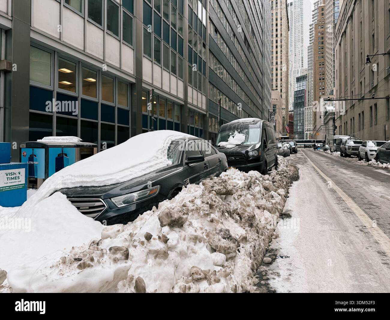 Snow-covered cars line a street in Manhattan, New York City, after a ...