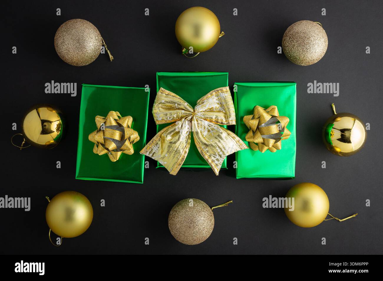 Gift box, shiny gold christmas balls, sparkling gold glitter on black ...