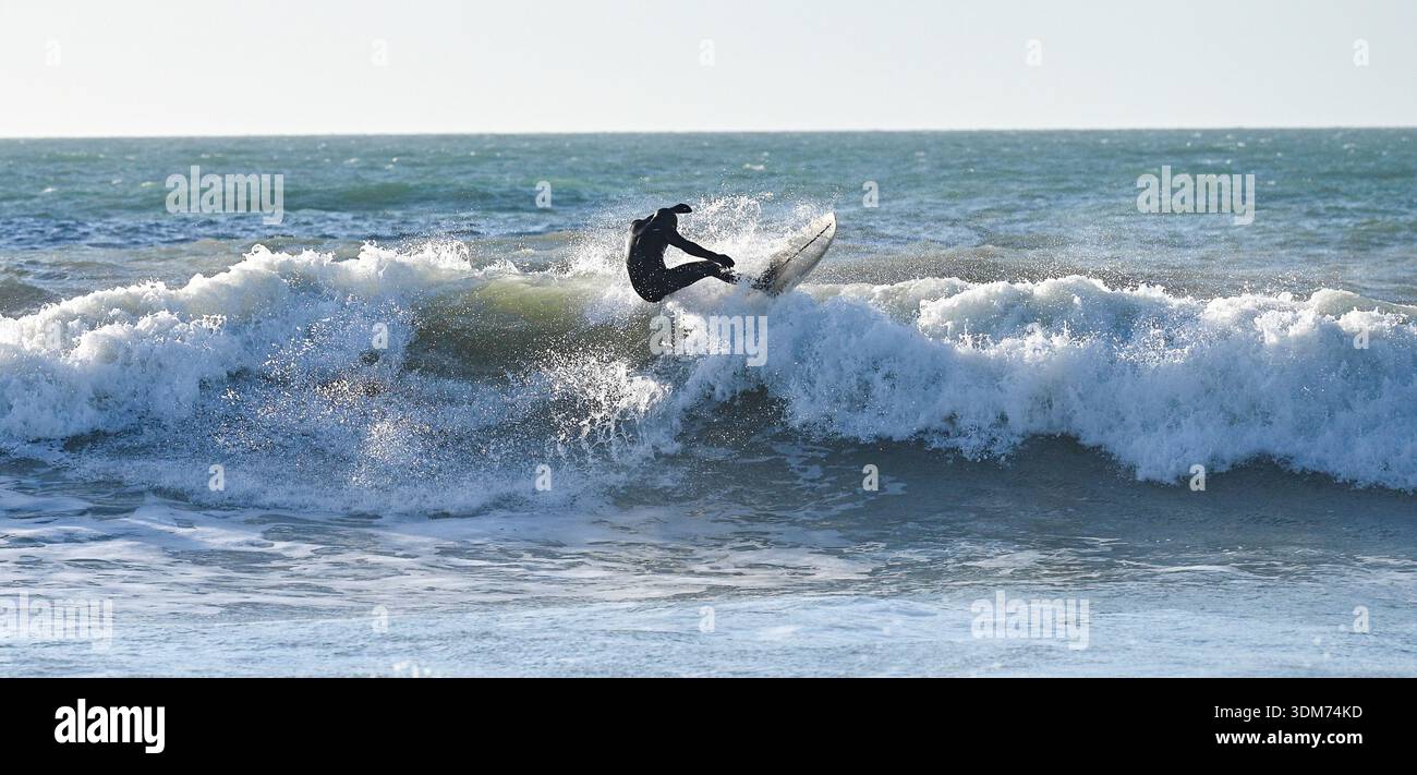 Brighton UK 4th February 2026 - A surfer makes the most of the sunny ...