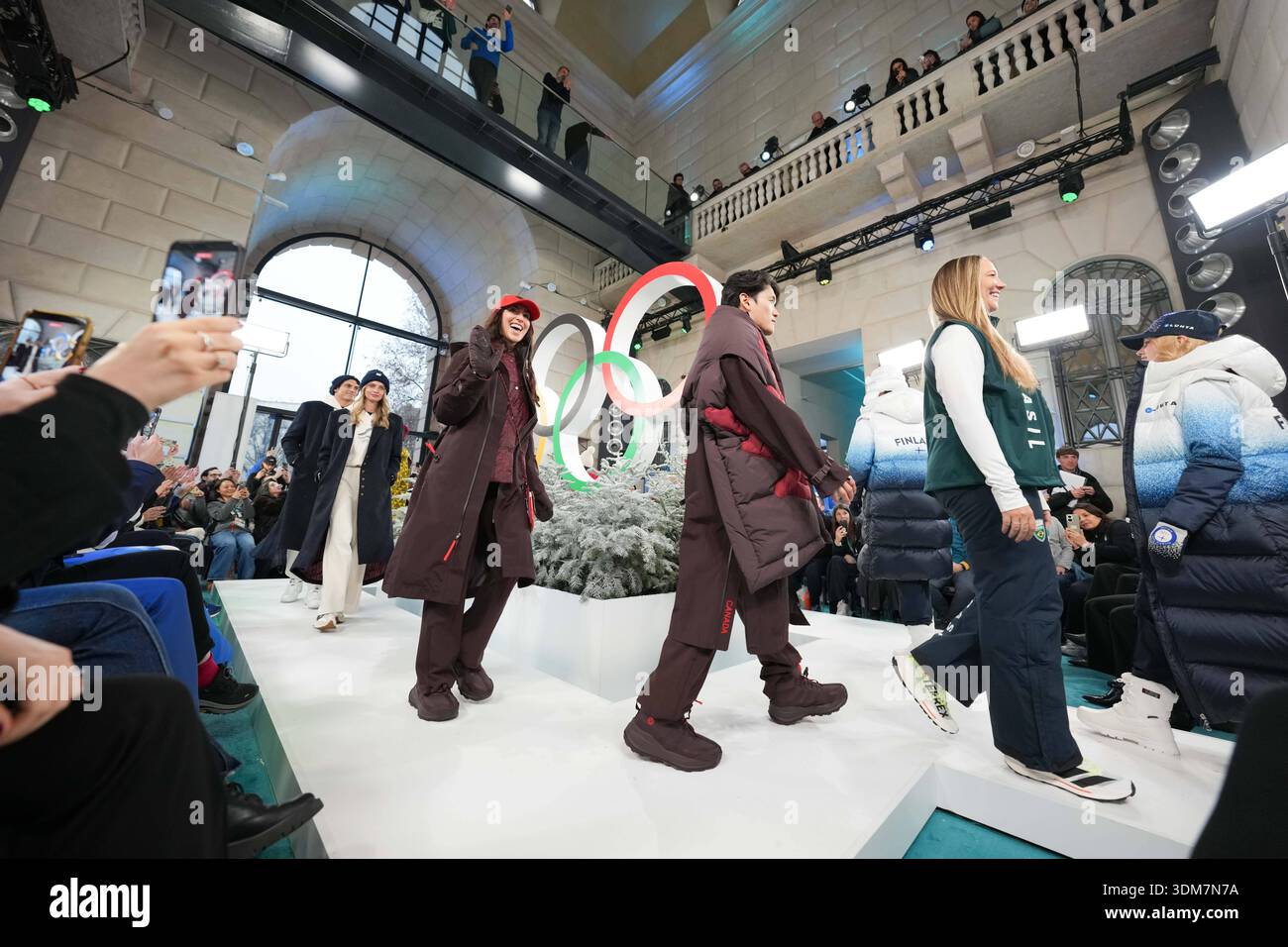 Athletes and models present outfits, during a fashion show ahead of the ...