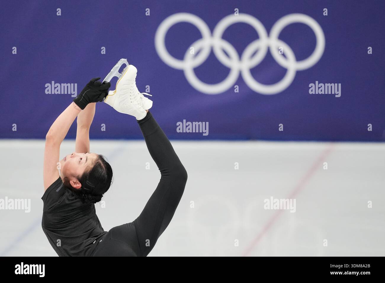 Ruiyang Zhang, of China, performs during a figure skating training ...