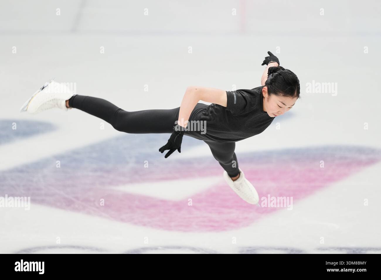 Ruiyang Zhang, of China, performs during a figure skating training ...