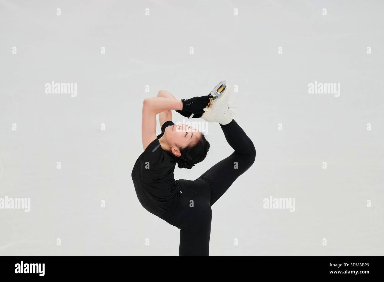Ruiyang Zhang, of China, performs during a figure skating training ...