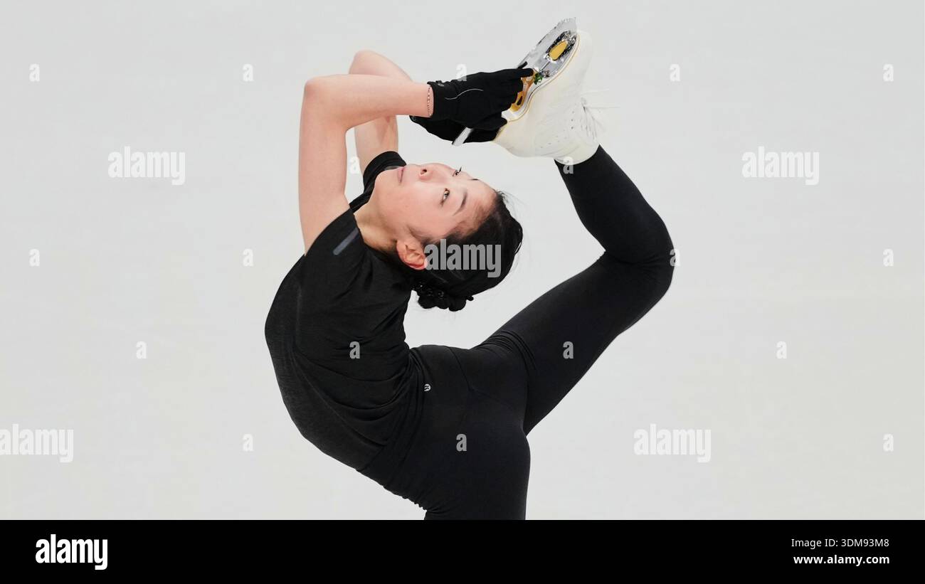 Ruiyang Zhang, of China, performs during a figure skating training ...