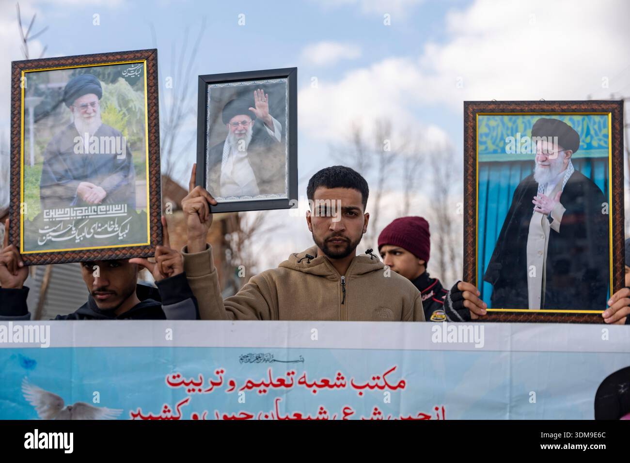 Kashmiri Shia Muslim men hold photographs of Iranian leader Ayatollah ...