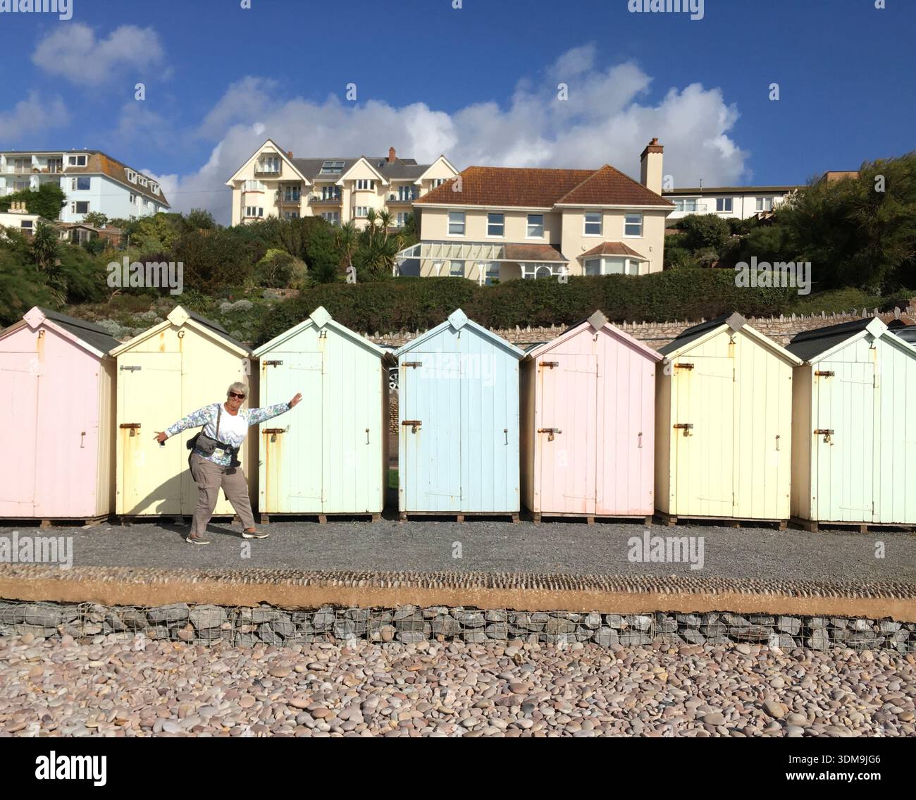 Elderly retired woman lady having fun at Budleigh Salterton seafront ...