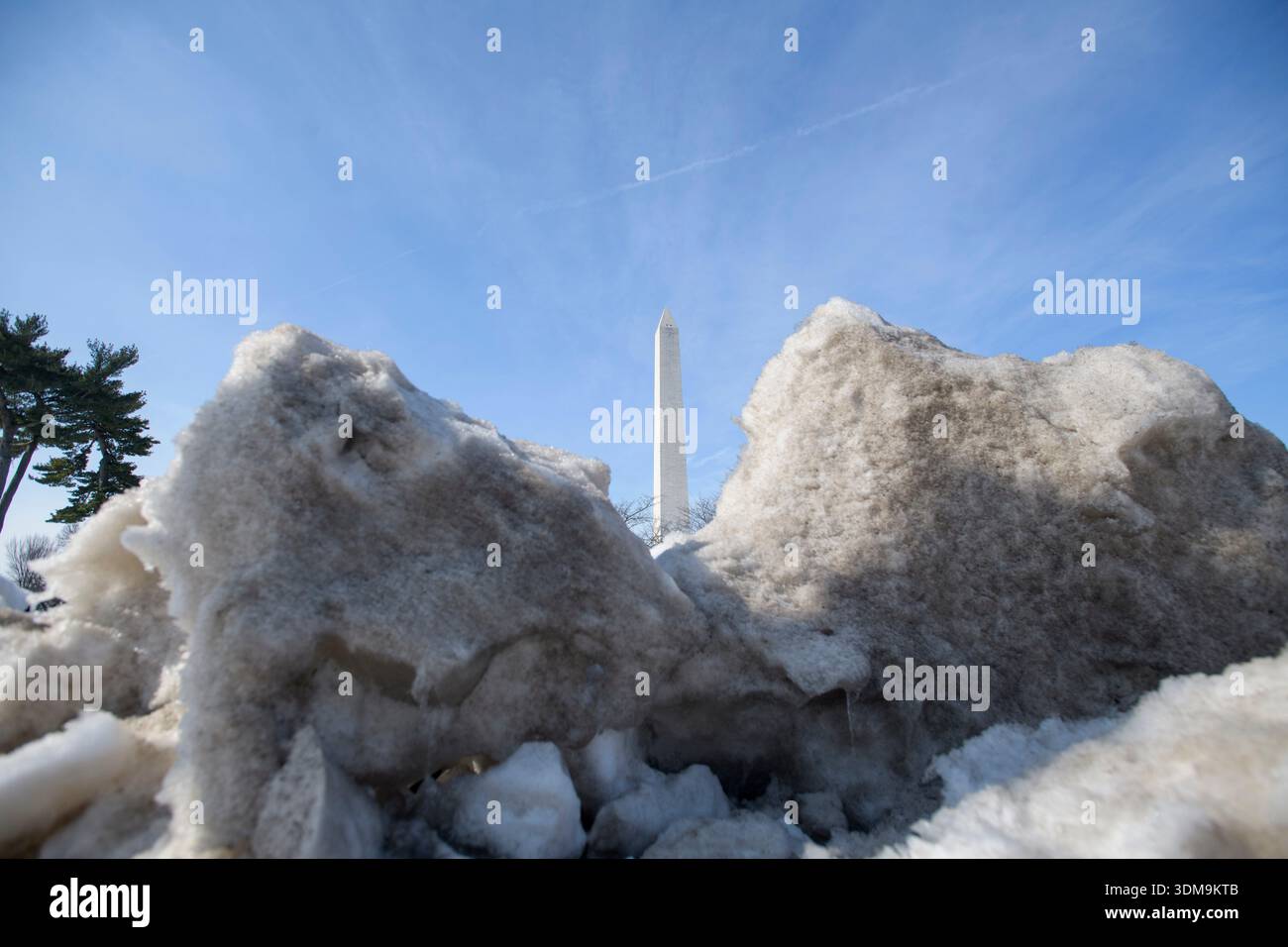 The Washington Monument is seen past piles of soot-covered snow after a ...