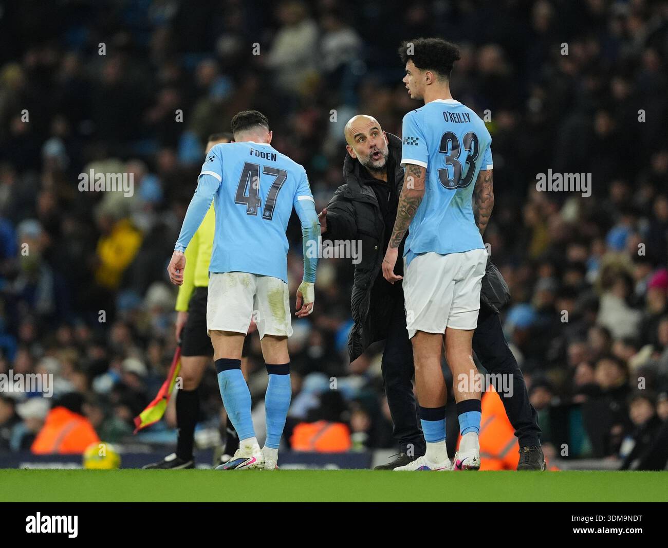 Manchester City manager Pep Guardiola speaks to Nico O'Reilly and Phil ...