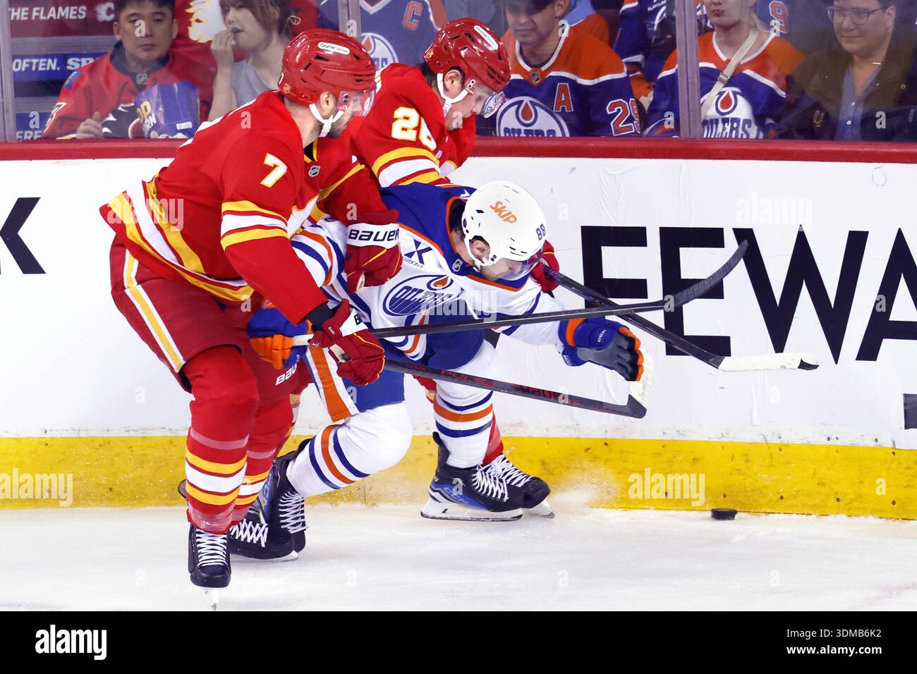 Calgary Flames' Kevin Bahl, left, and Zach Whitecloud, center top, keep ...