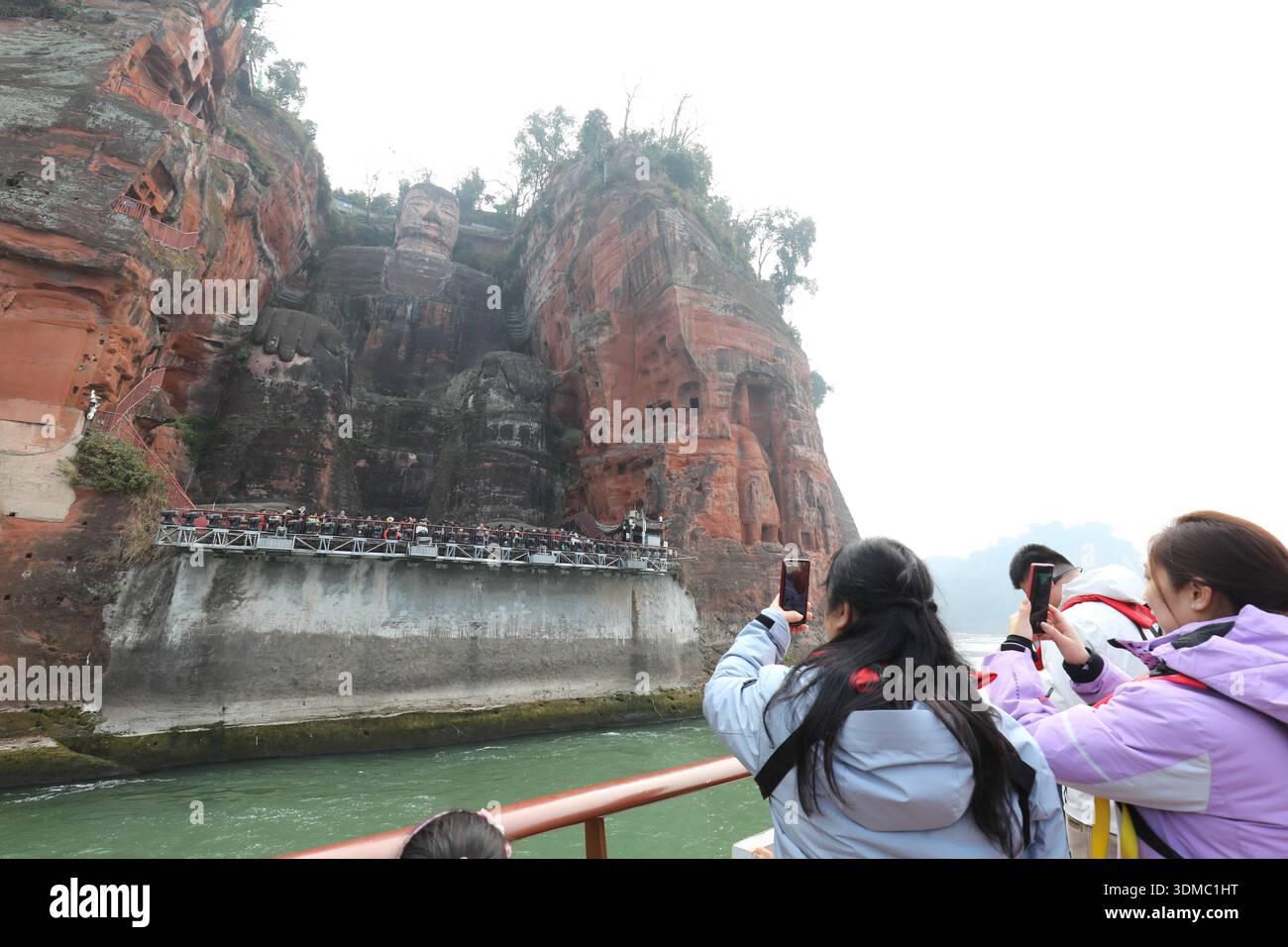 Tourists visit the Leshan Giant Buddha scenic area in Leshan City ...