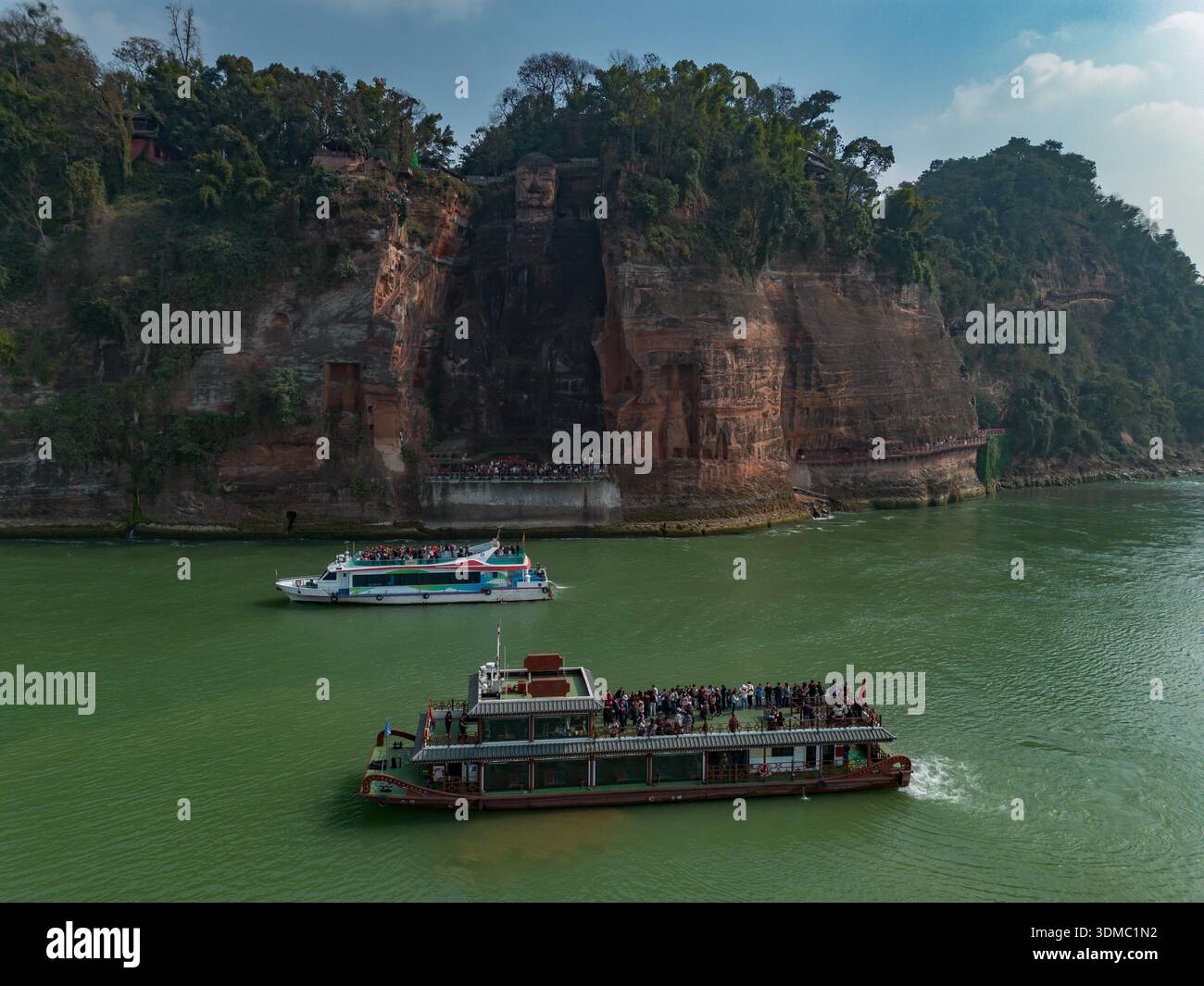 Tourists visit the Leshan Giant Buddha scenic area in Leshan City ...