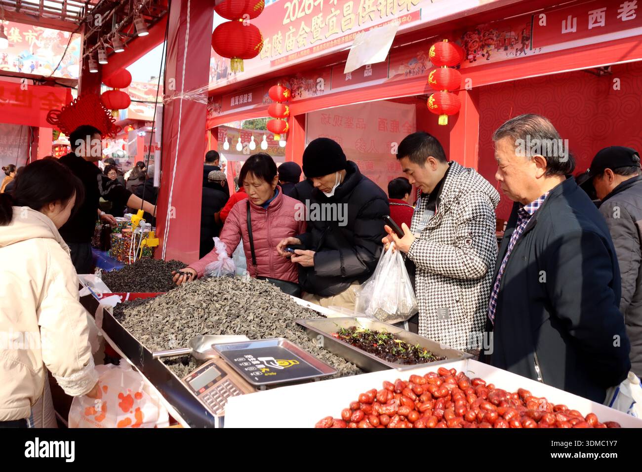 Visitors browse specialty goods at a temple Fair in Yichang City ...