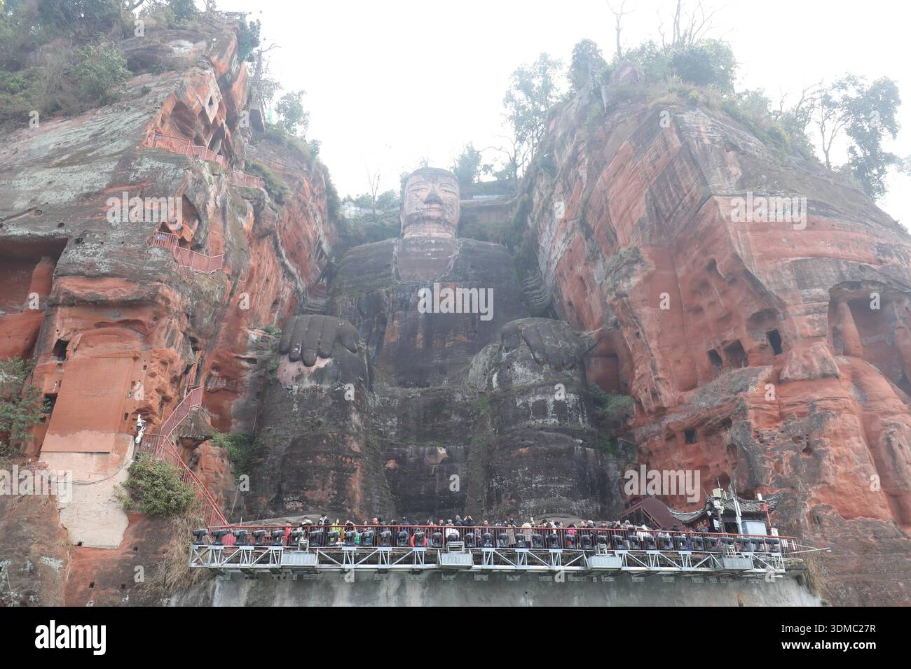 Tourists visit the Leshan Giant Buddha scenic area in Leshan City ...