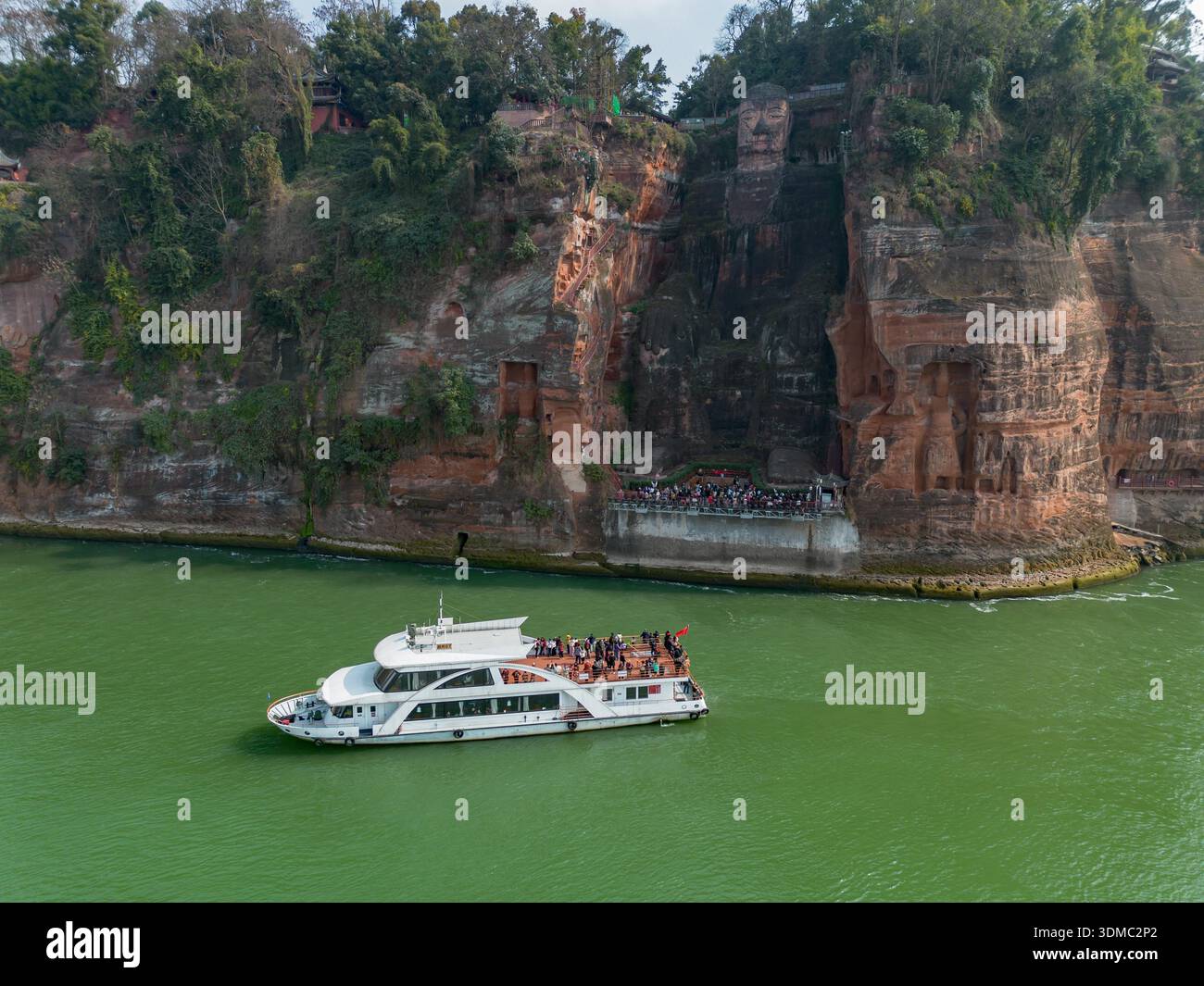 Tourists visit the Leshan Giant Buddha scenic area in Leshan City ...