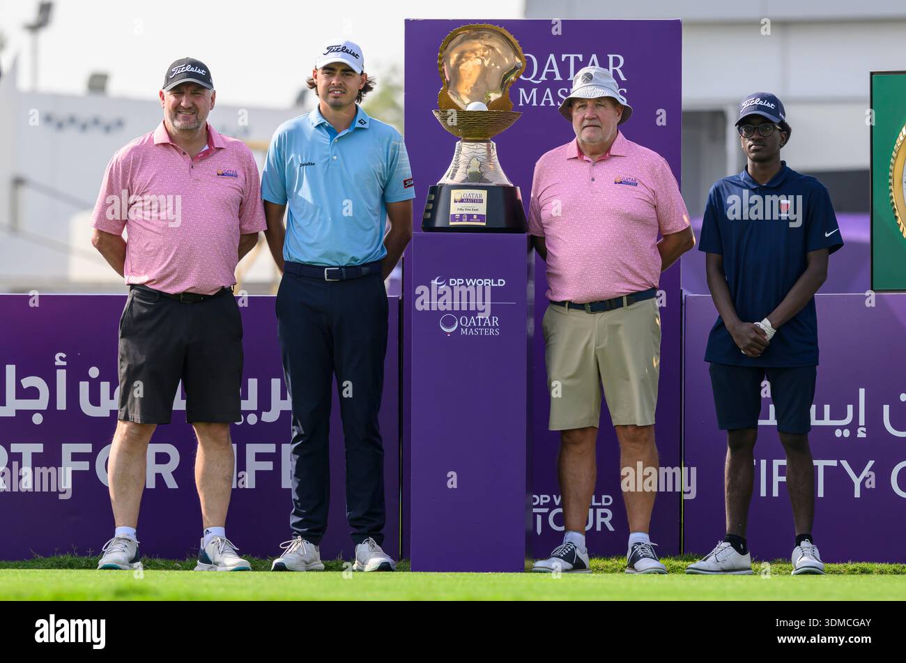 Participants pose for a photograph with the tournament trophy on ...