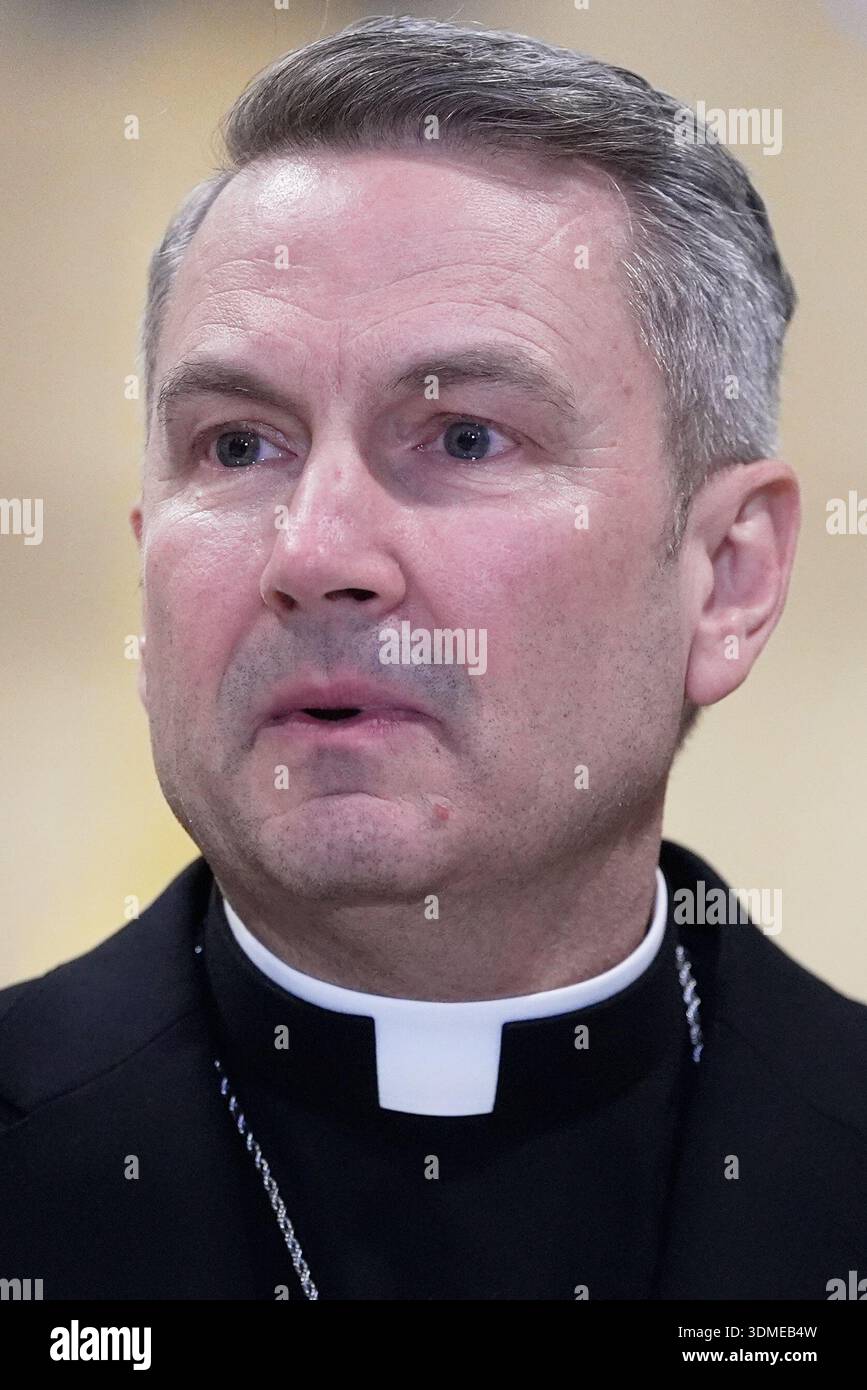 Archbishop-designate Ronald Hicks talks to reporters during a news ...