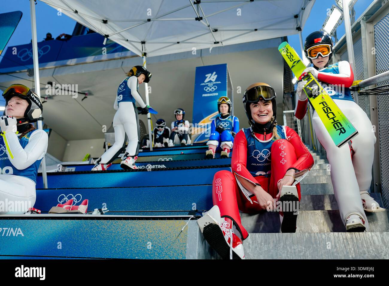 Sina Arnet, of Switzerland, smiles while waiting her turn to jump ...