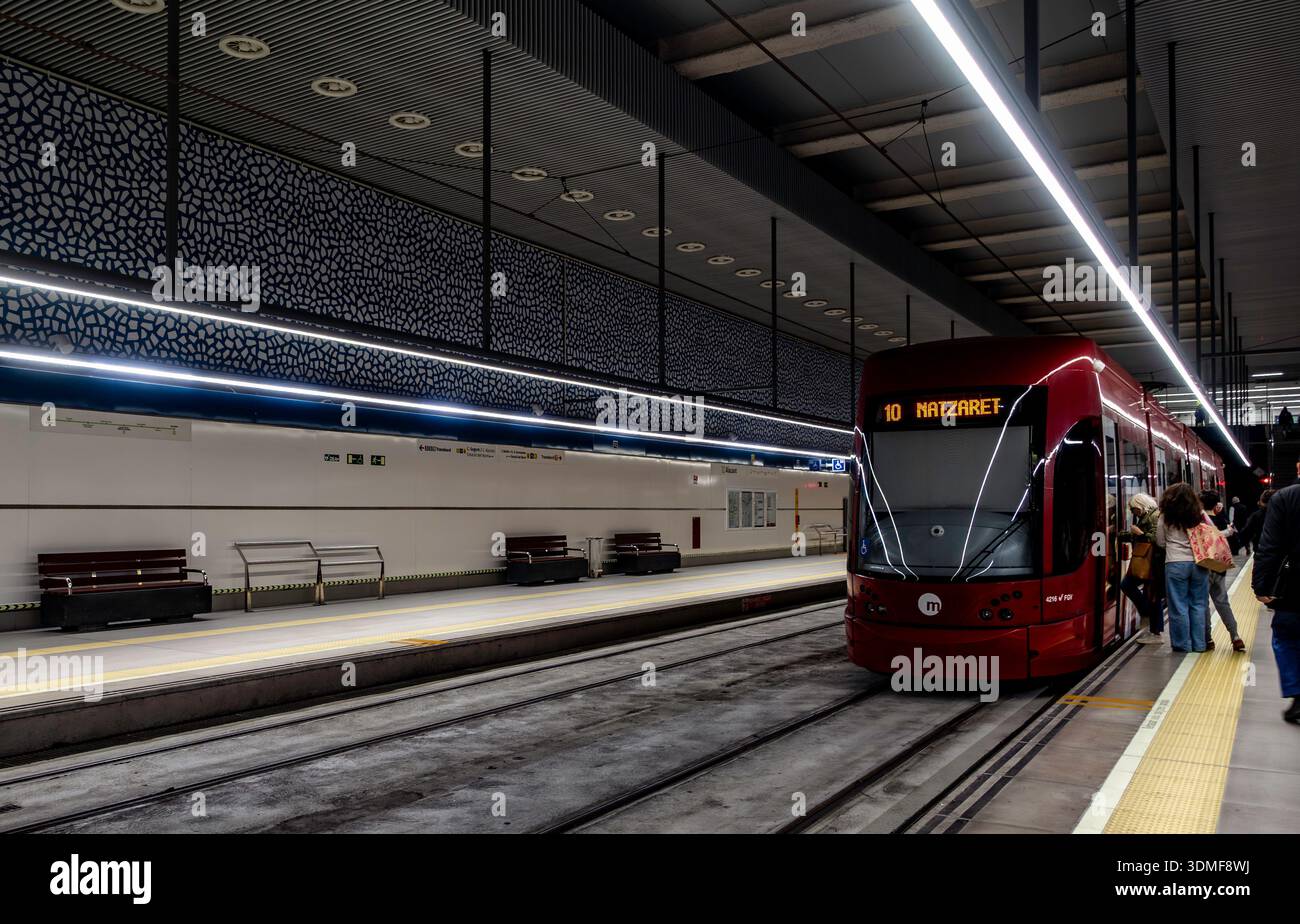 Modern red metro train at Alacant station in Valencia, Spain, featuring ...
