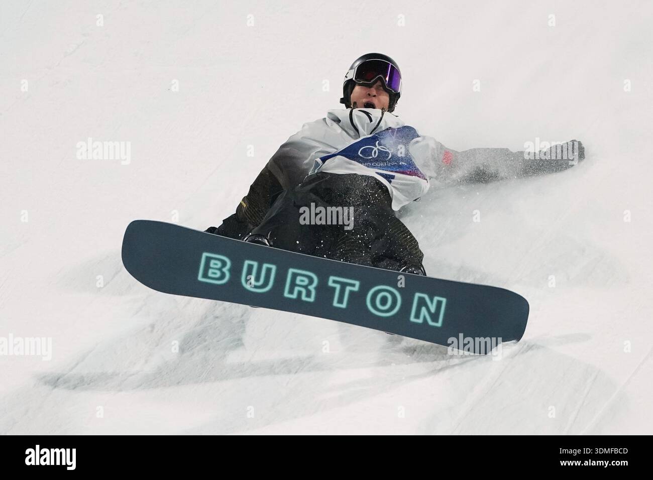 China's Ge Chunyu reacts as he falls during men's snowboard big air ...