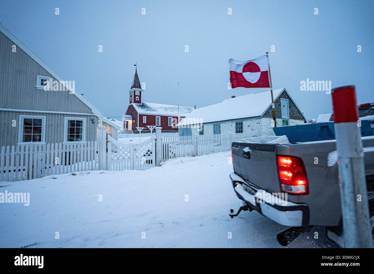 A truck flying a flag of Greenland drives in Nuuk, Greenland, on ...
