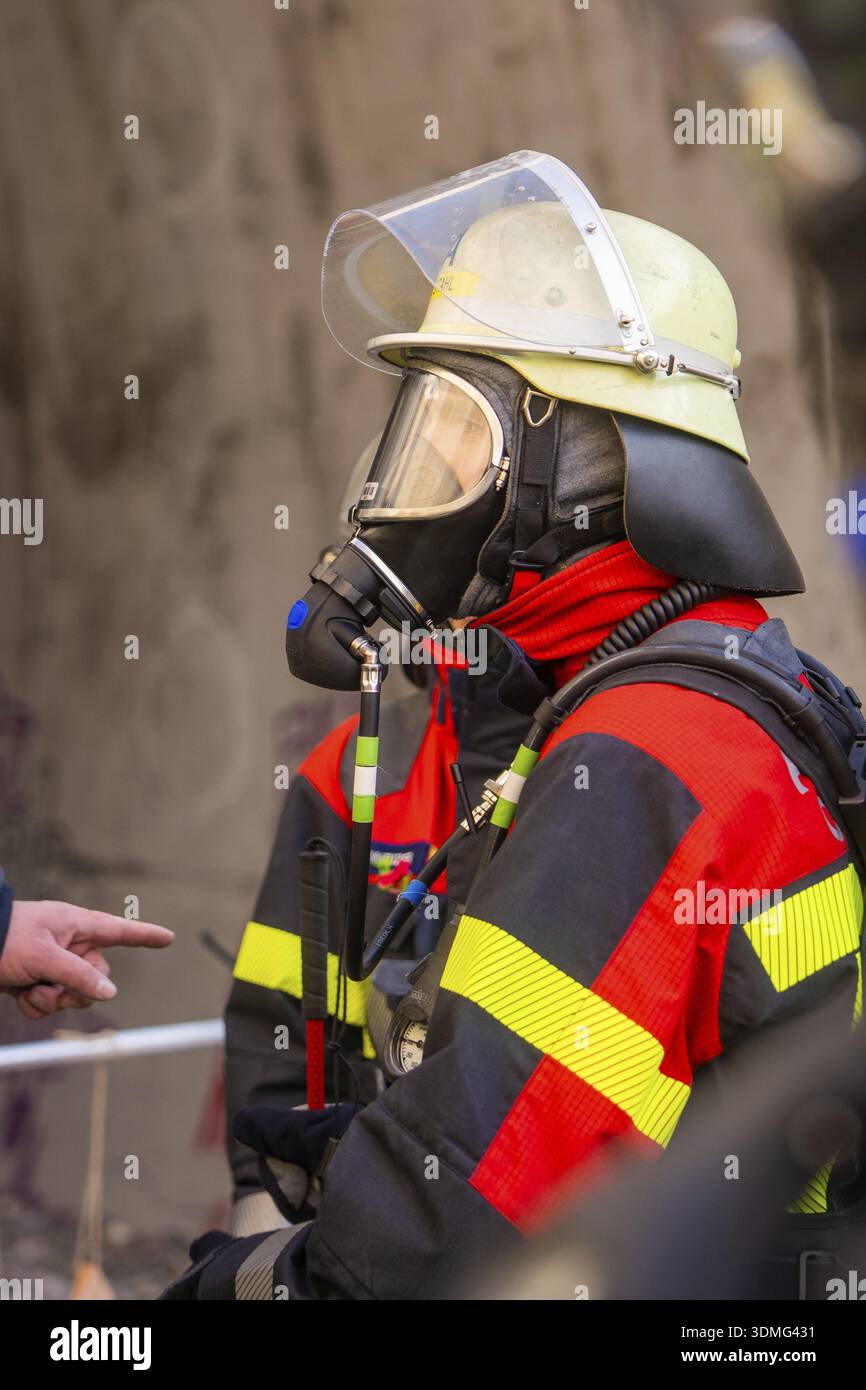 Firefighter with respirator and helmet, focused and ready for rescue ...