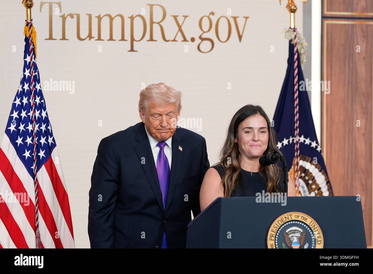 President Donald Trump listens as Catherine Rayner speaks about TrumpRx ...