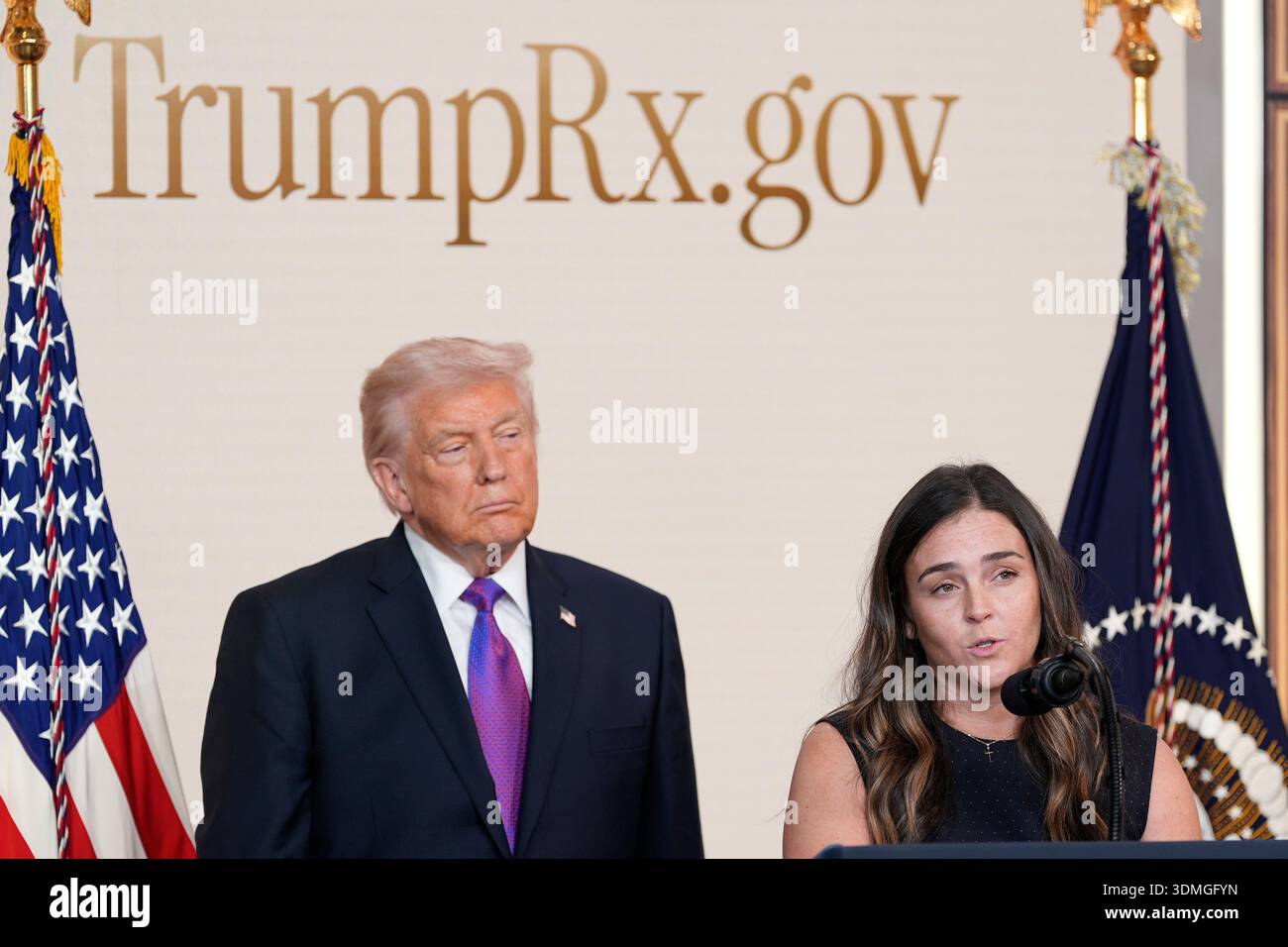 President Donald Trump listens as Catherine Rayner speaks about TrumpRx ...