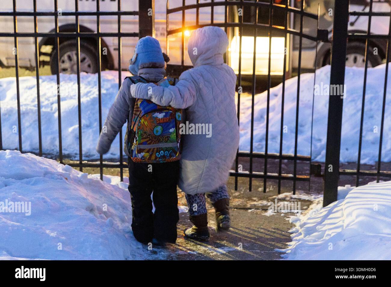 Giancarlo, 10, is escorted by his mom to the curb for bus pickup ...