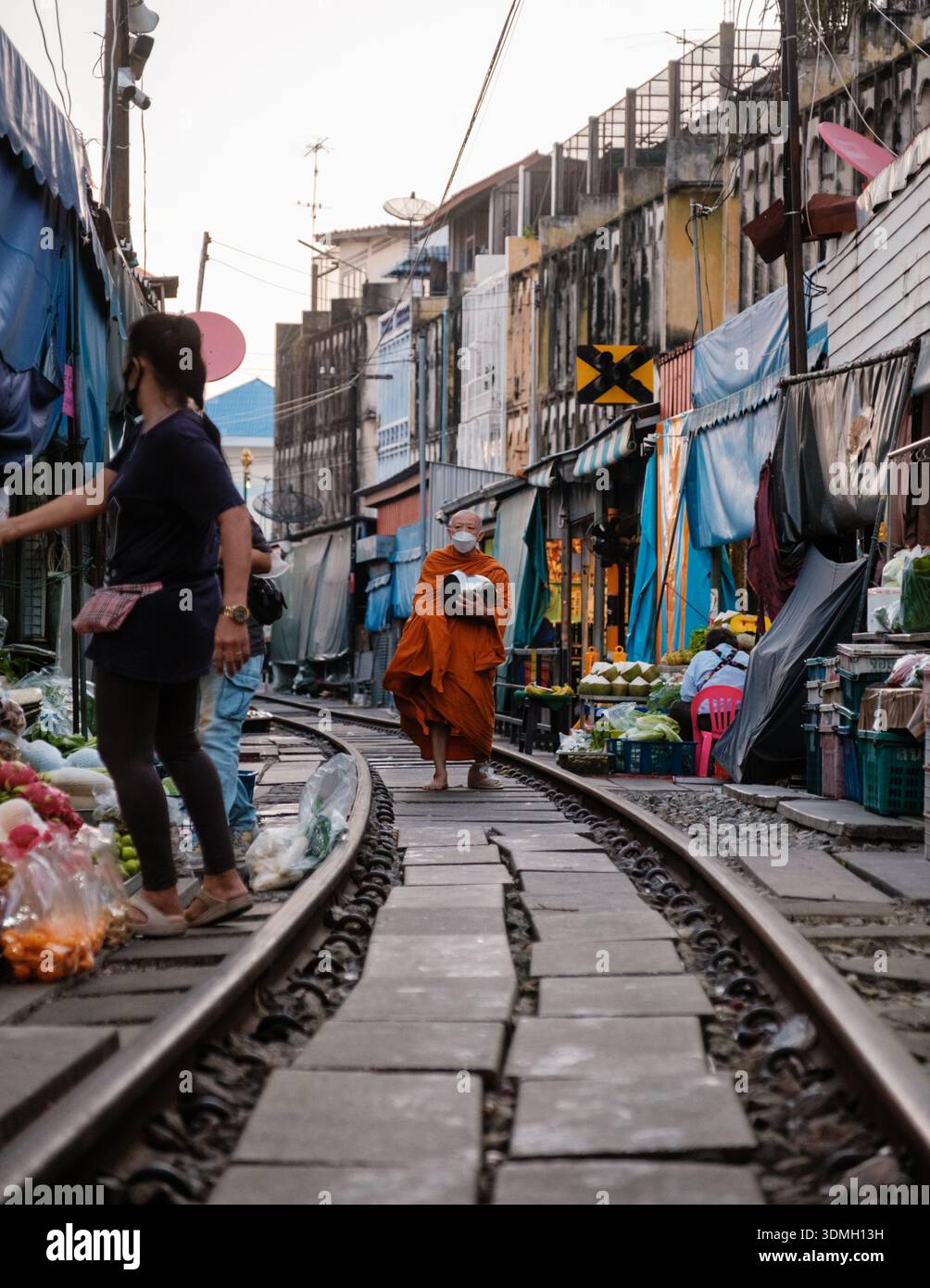 Maeklong Railway Market in Thailand, December 5, 2025, a monk in an ...