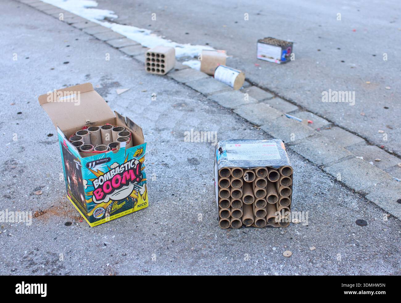 A scattered assortment of cardboard boxes filled with cylindrical ...