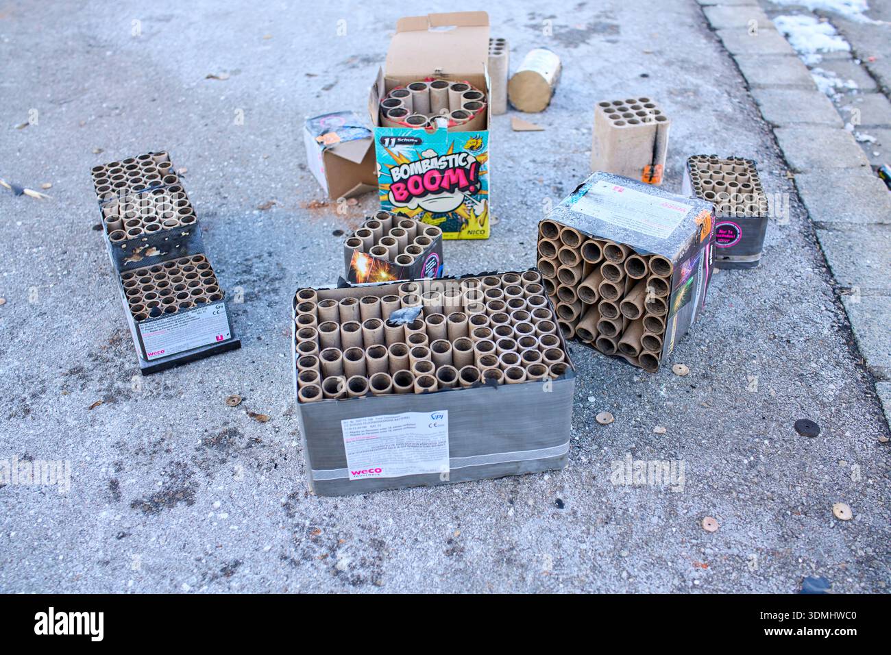 A scattered assortment of cardboard boxes filled with cylindrical ...