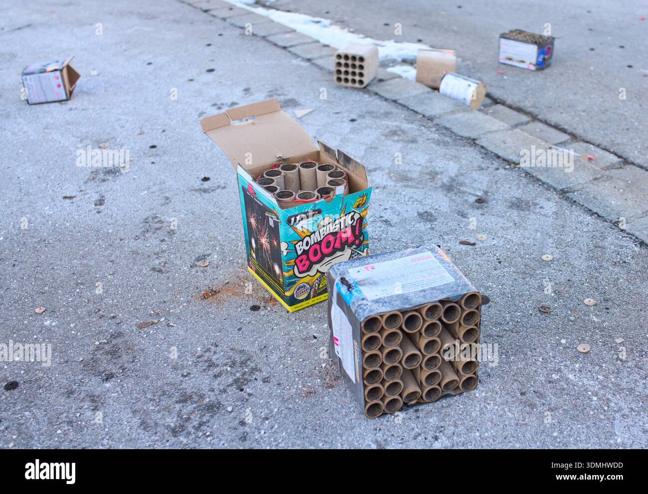 A scattered assortment of cardboard boxes filled with cylindrical ...