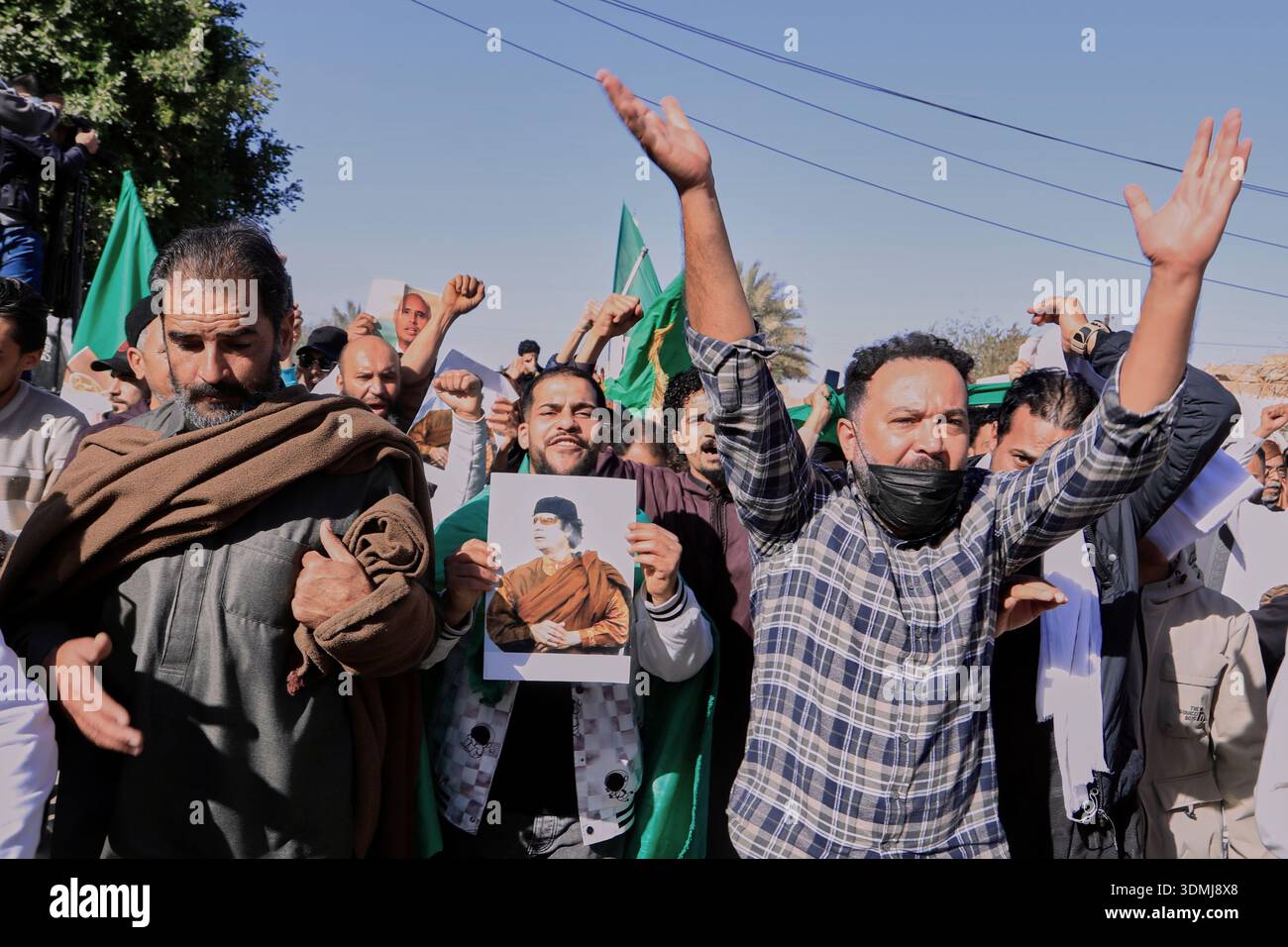 Libyans march to attend the funeral of Seif al-Islam, son of former ...