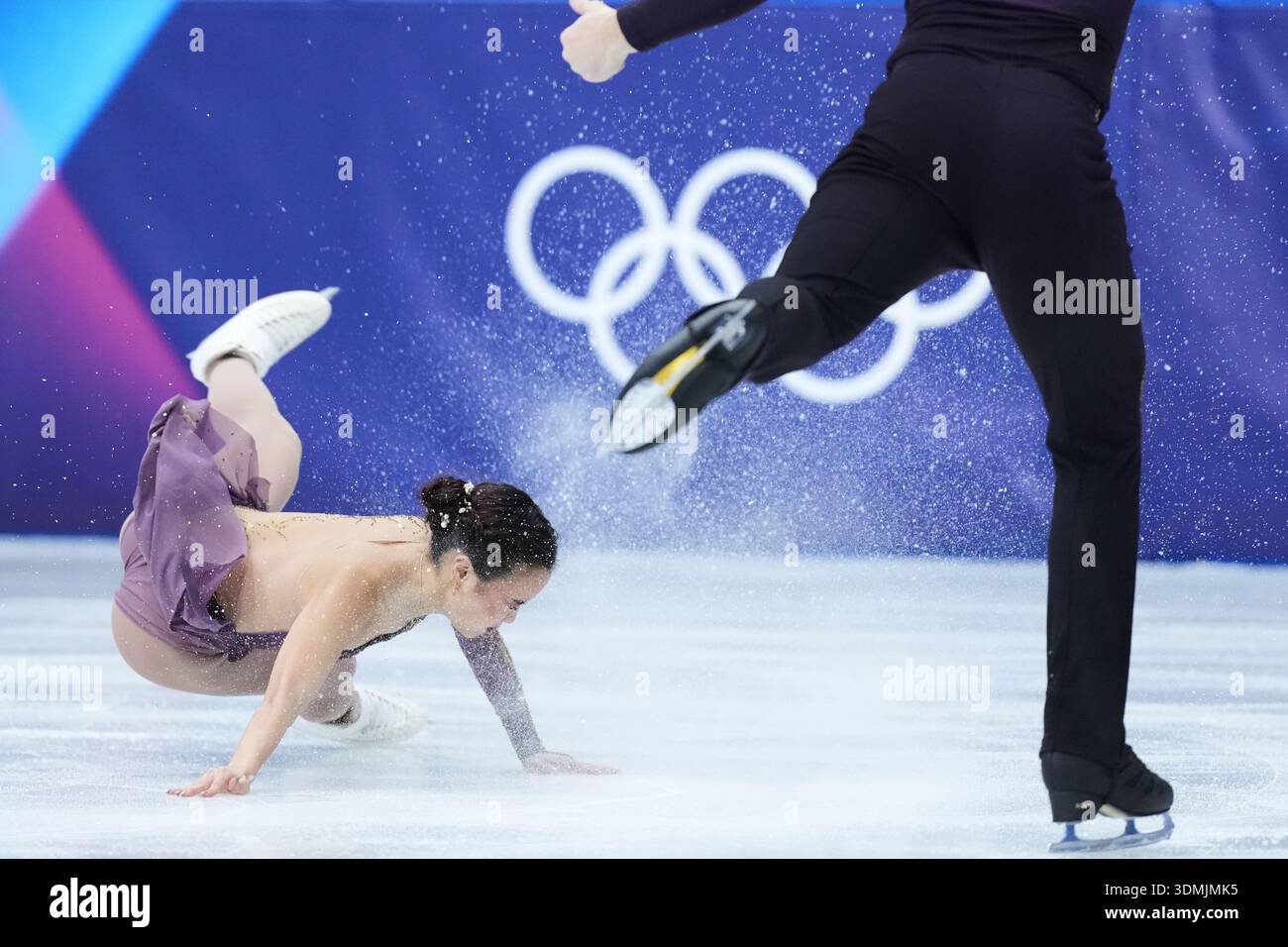 Ellie Kam falls while competing with her partner Danny O'Shea of the ...