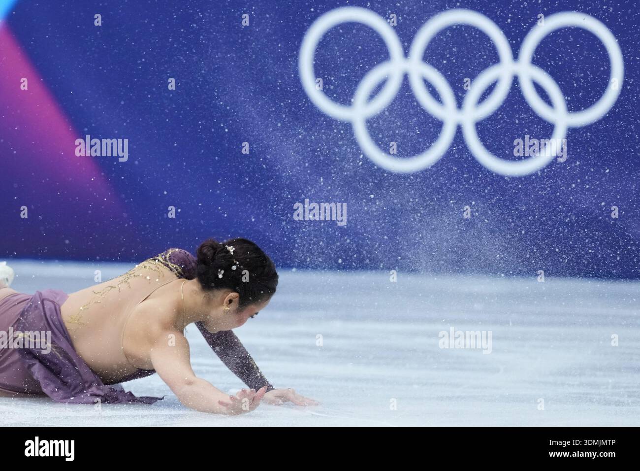 Ellie Kam falls while competing with her partner Danny O'Shea of the ...